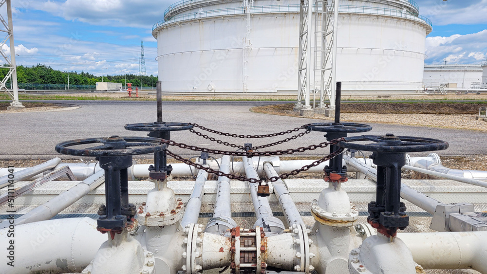 Foto de Valves locked by chain on the petrochemical tank farm with ...