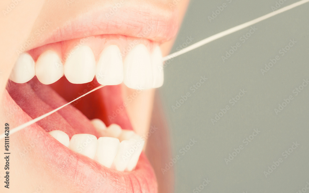 Dental flush - woman flossing teeths. Dental floss. Taking care of ...