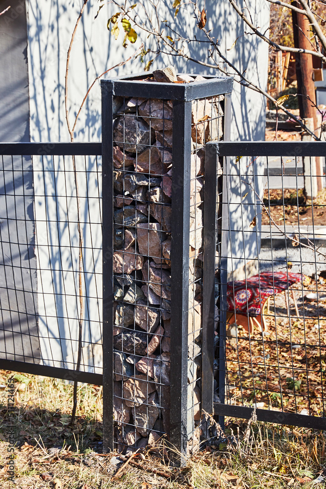 fence post made of steel corners and wire and filled with stones Stock ...