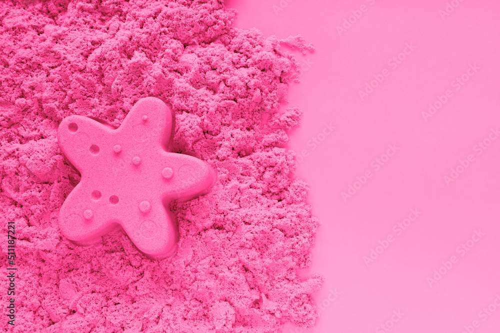 Pink kinetic sand with starfish sand figure on light pink paper ...