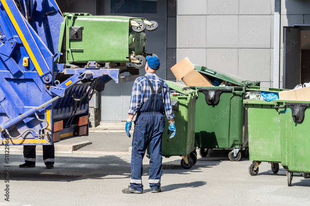 refuse collection worker loading garbage for trash removal Stock Photo ...