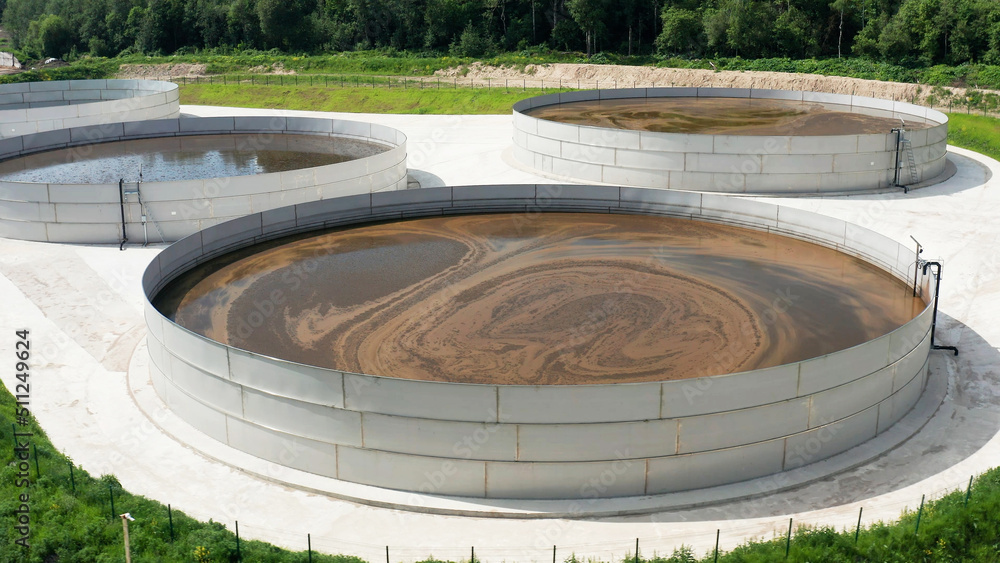 Tanks with liquid manure on the territory of a livestock farm. Aerial ...