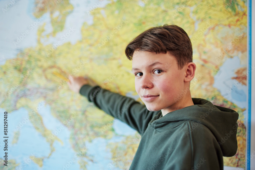 Portrait of boy pointing on map in class Stock Photo | Adobe Stock