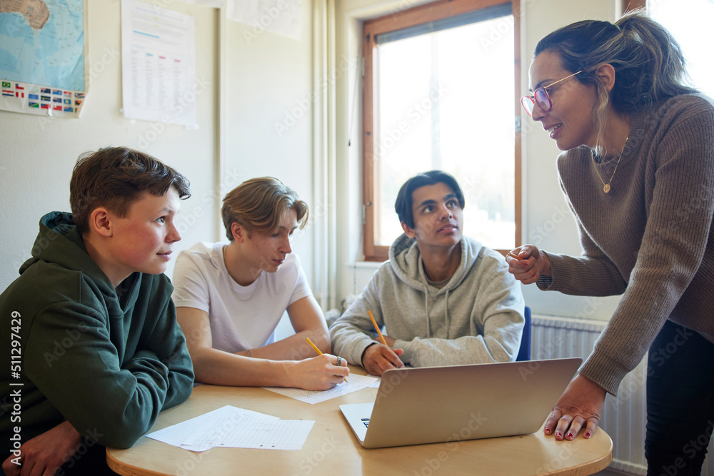 Teacher talking to students in class Stock Photo | Adobe Stock