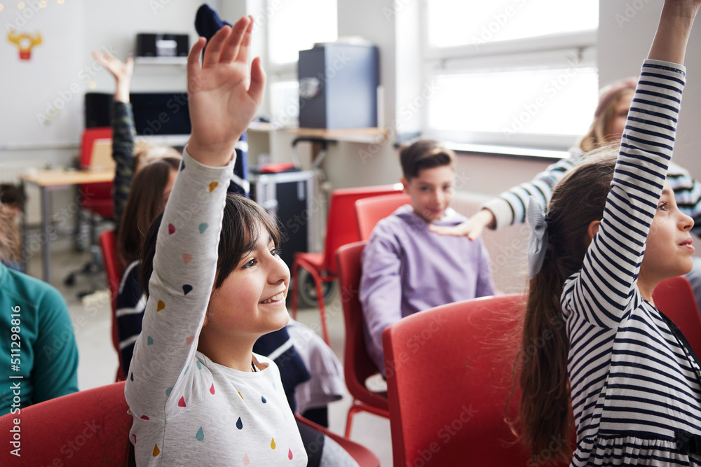 Children raising hands in class Stock Photo | Adobe Stock