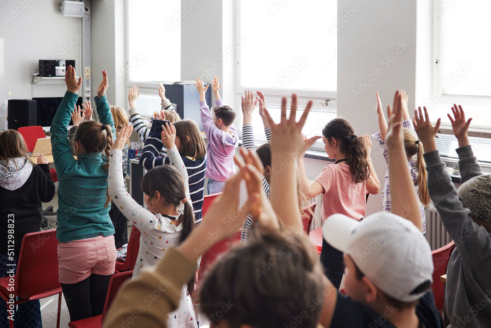 Children raising hands in class Stock Photo | Adobe Stock