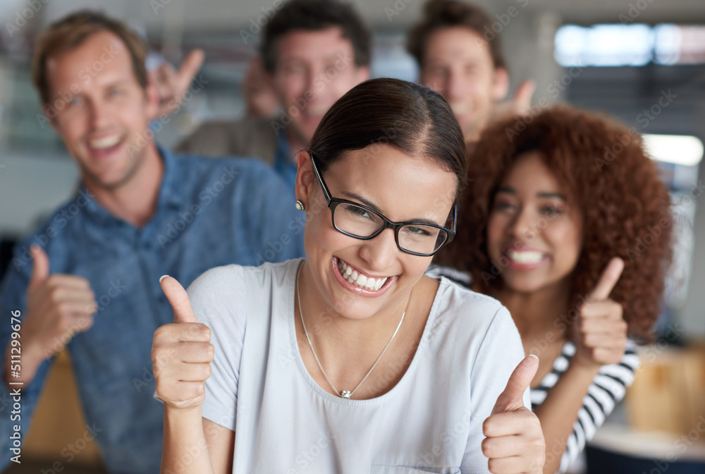 Were winning all the way. Smiling young woman giving a thumbs up to the ...
