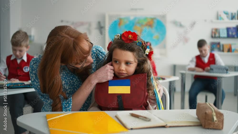 Teacher with Ukrainian schoolgirl in classroom, concept of enrolling ...