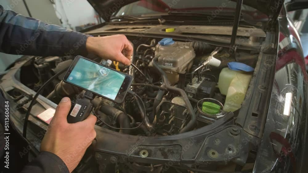 Video Stock Hands of car mechanic check the vehicle engine with ...