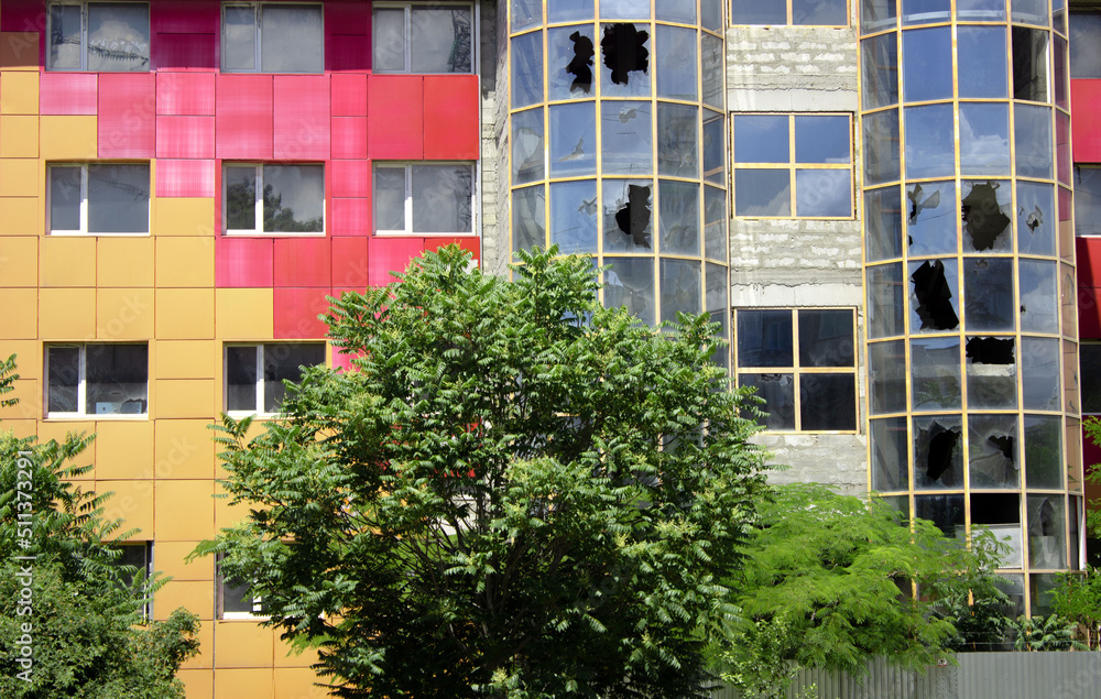 Shattered glass of an office building. Modern commercial building with ...