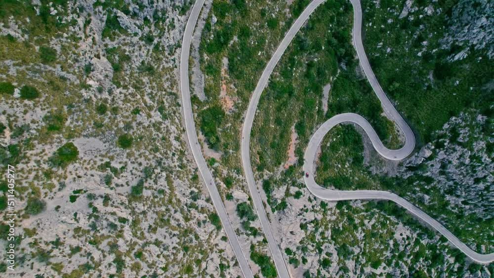 Cars, buses and motorcycles drive on European curved road in Majorca ...