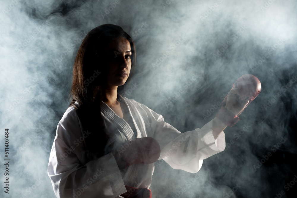 beautiful girl exercising karate pose against fog background.. Stock ...