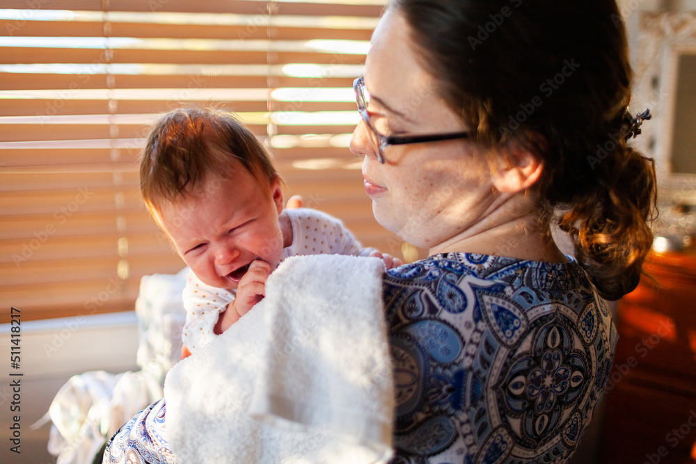 Young mother comforting sad crying baby child Stock Photo | Adobe Stock