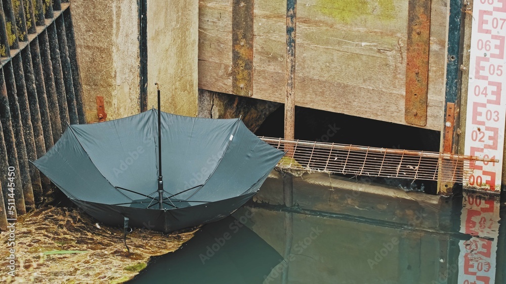 Black Textile Umbrella Caught in Storm Sewer Water Lock Gate after ...