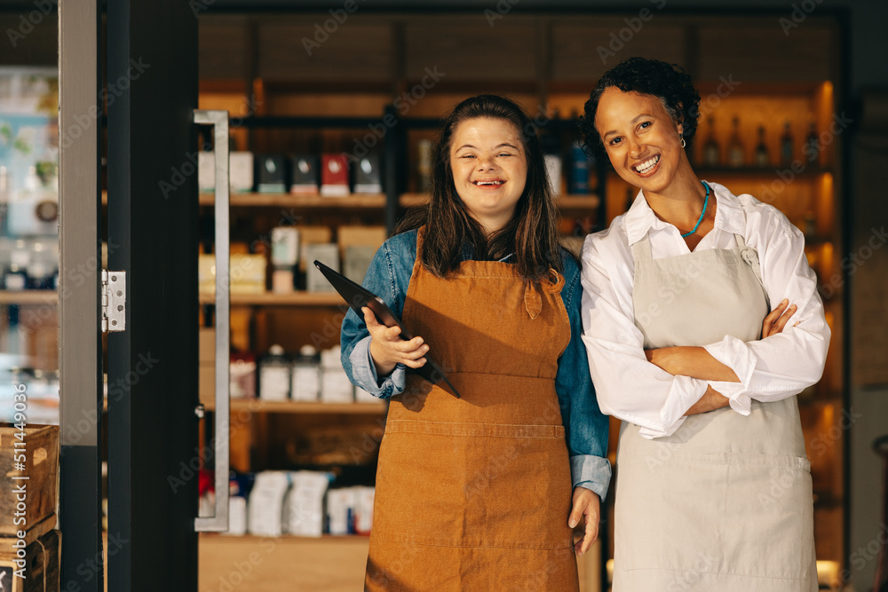 Two successful shop employees smiling at the camera happily Stock Photo ...