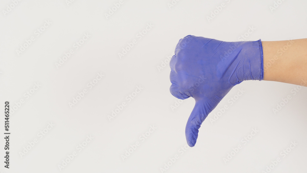 The dislike or thumbs down hand sign on white background. The hand is ...