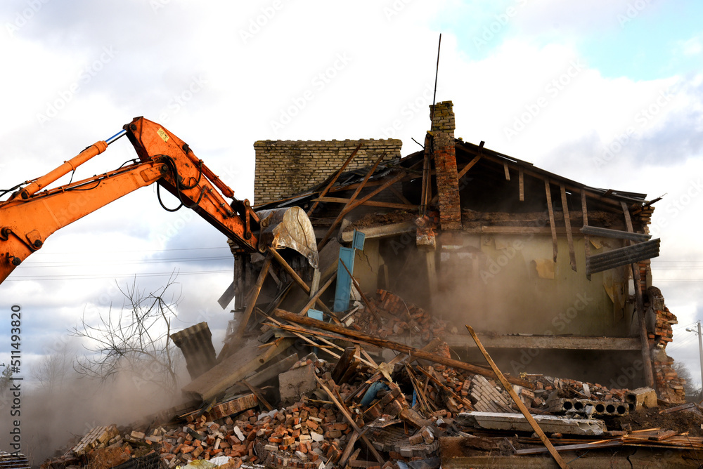 Demolition the house in the rural. Excavator bucket destruction old ...