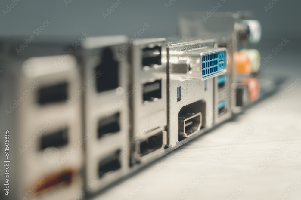 Blurred motherboard. HDMI, DVI, USB ports on the back of the computer motherboard to connect ...