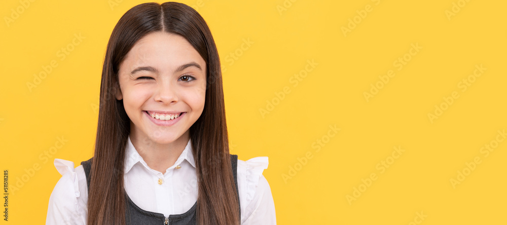 Happy school age girl child with smiling face give wink yellow ...