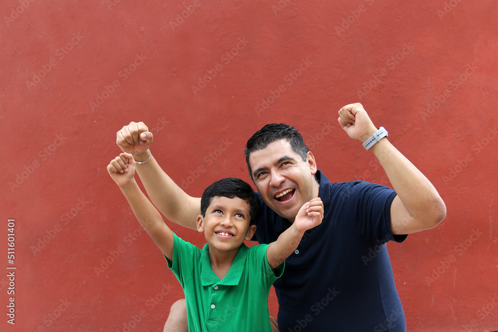Single dad and dark-haired Latino son play and have fun together ...