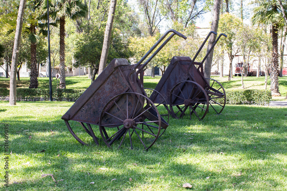 old metal wheelbarrow in a train railway museum, museo del ferrocarril ...