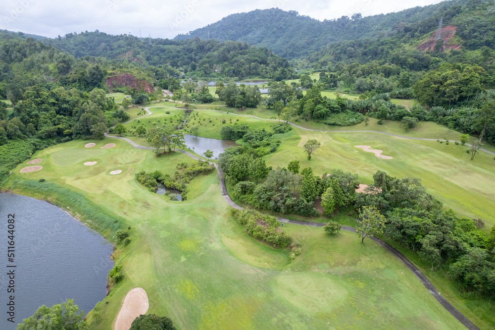 Aerial view drone shot of beautiful green golf field fairway and ...