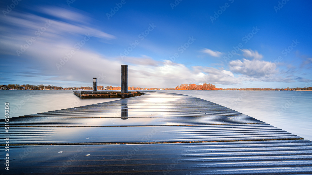 Floating curved pier on a dutch lake Stock Photo | Adobe Stock
