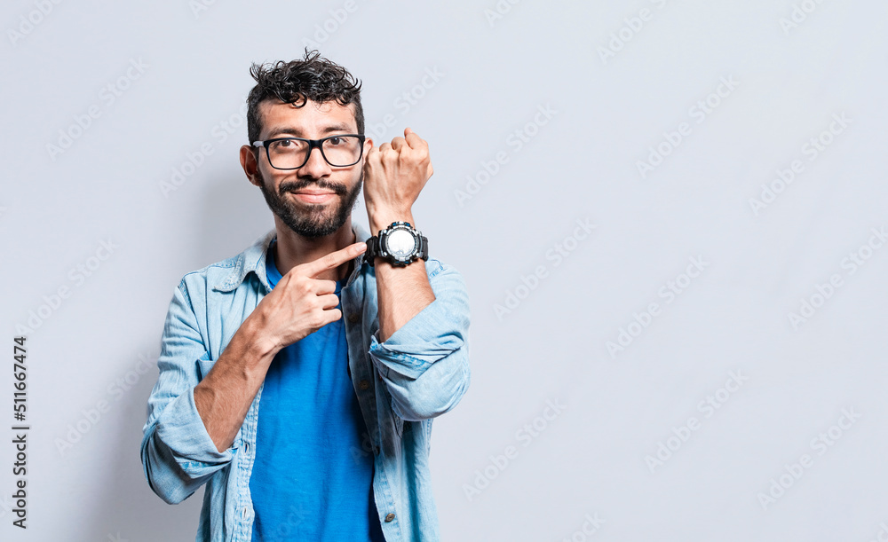 Person pointing at his watch looking at the camera. Friendly man ...