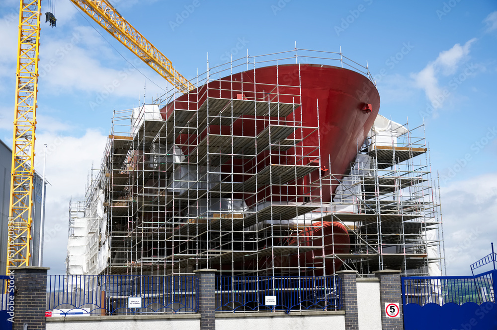 Shipbuilding and crane during ferry construction surrounded by scaffold ...