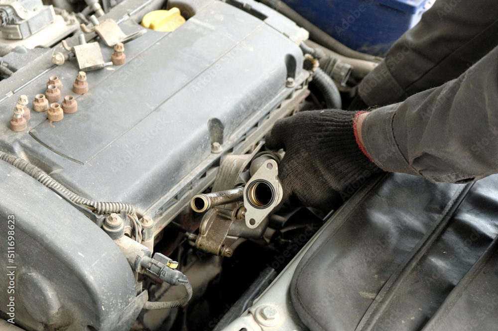 Repair of internal combustion engines. The car mechanic holds in his ...