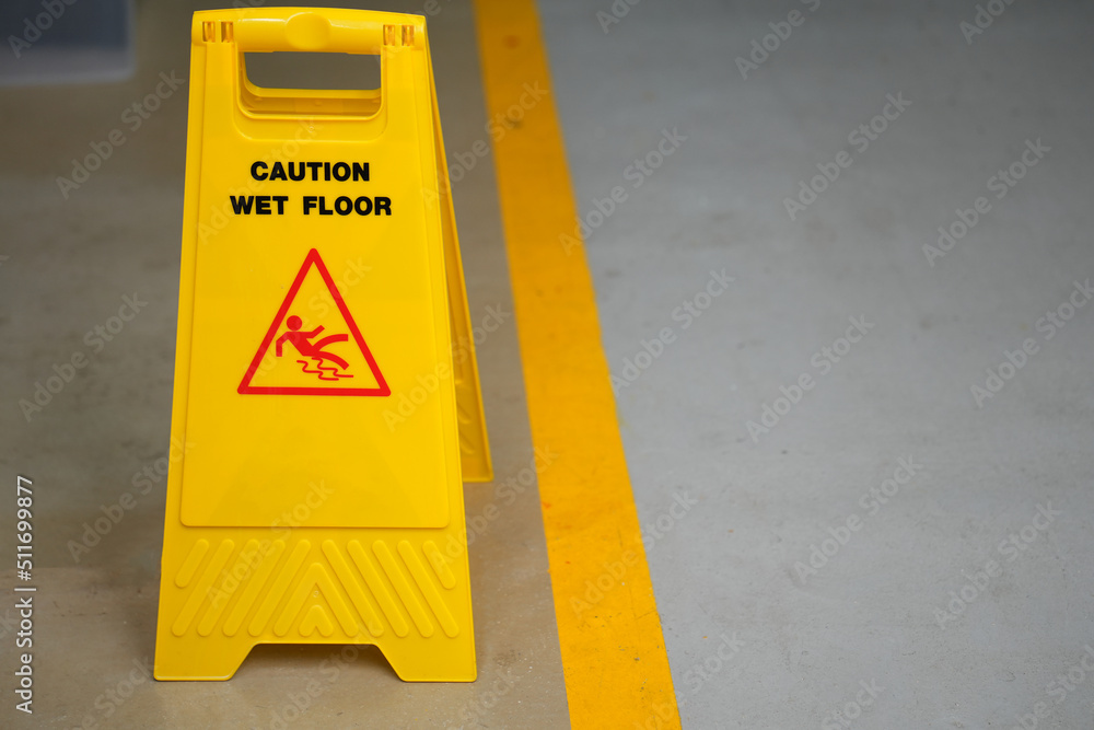Warning sign for wet floor in the factory office Stock Photo | Adobe Stock