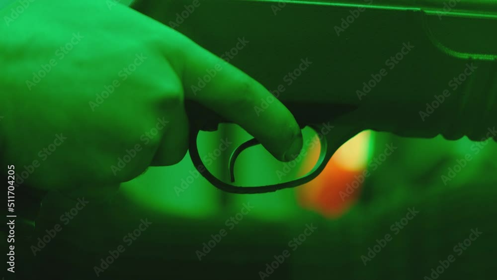 Weapon shot . Close-up finger pulls the trigger of rifle . Pulling the ...