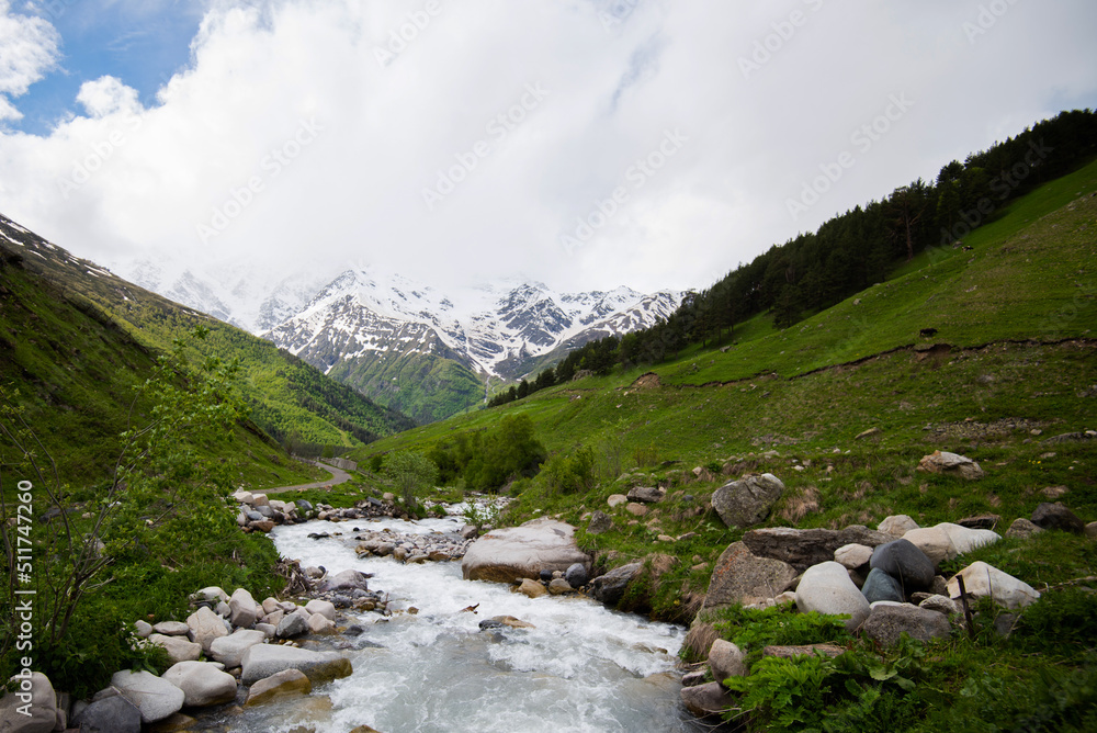 Picturesque mountain landscape with a small river and the Caucasian ...