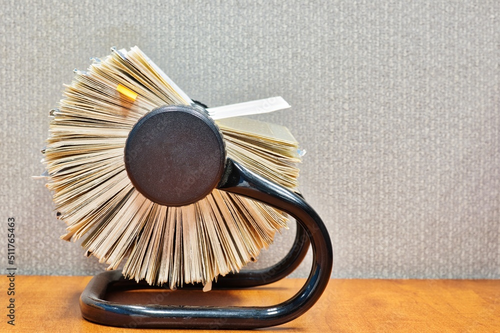 Rolodex file organizer on office desk, side view with gray cubicle ...