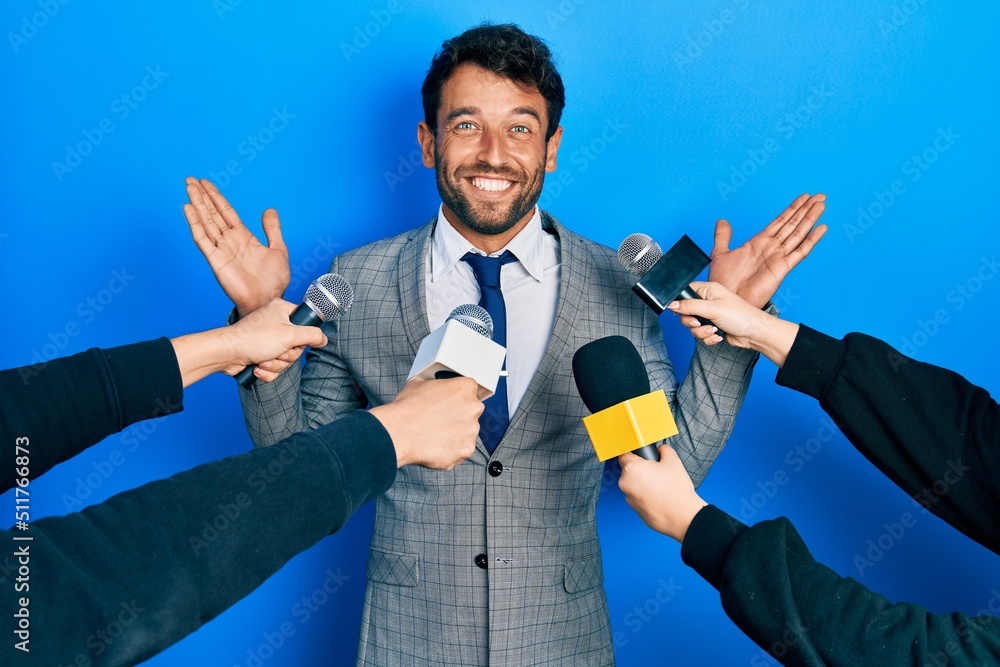 Handsome man business with beard being interviewed by reporters holding ...