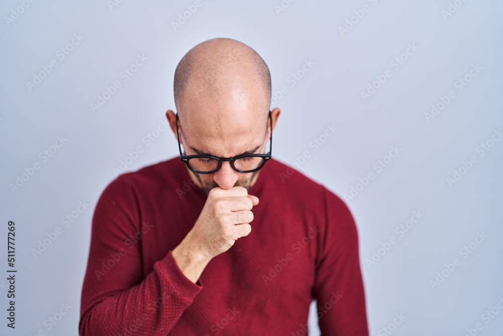 Young bald man with beard standing over white background wearing ...