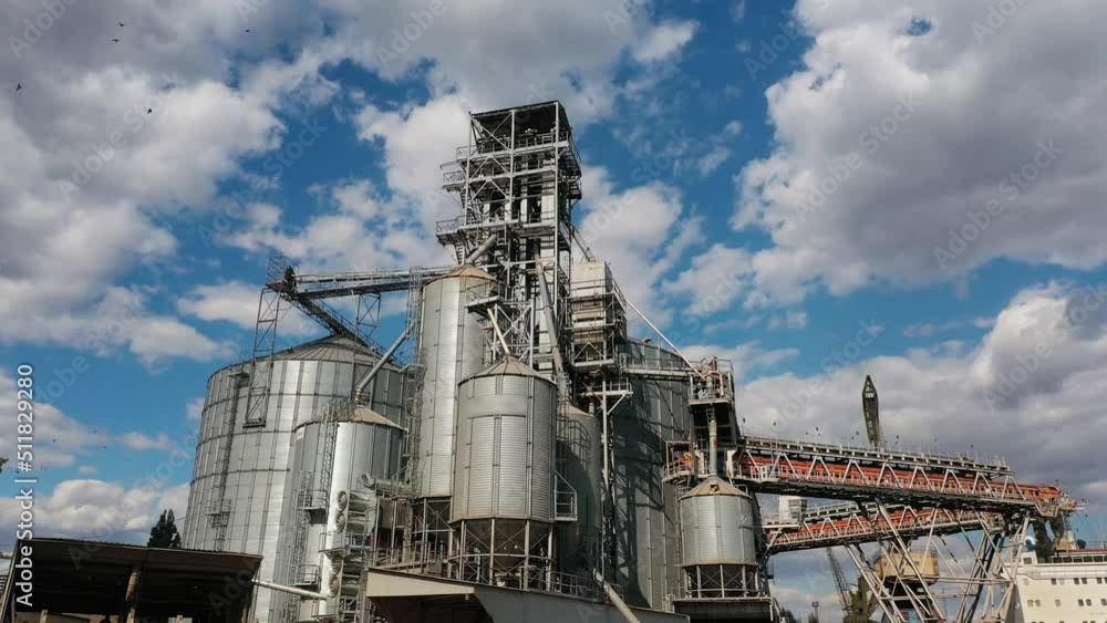 Sea grain elevator at seaport berth with moored bulker ship. Grain ...