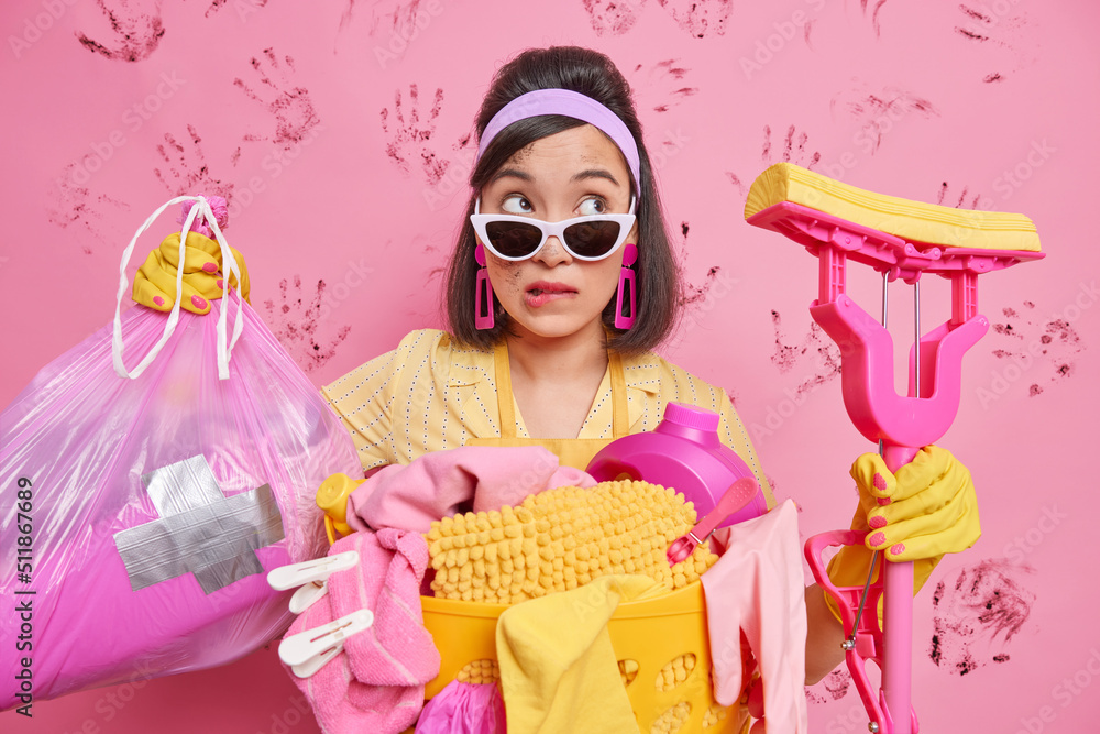 Chores and domestic duties concept. Asian woman wears sunglasses ...