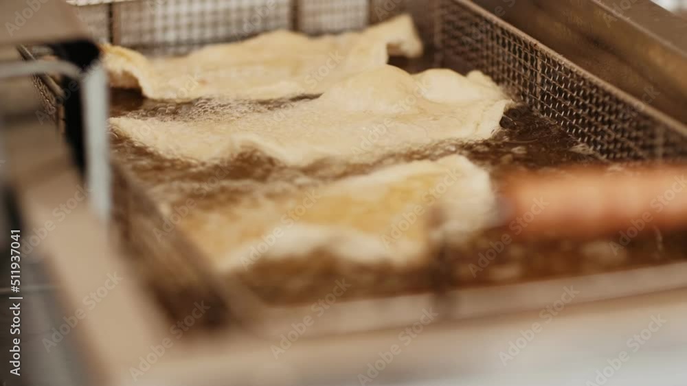 Concept of unhealthy junk very fat food. Deep frying of bakery pastry ...