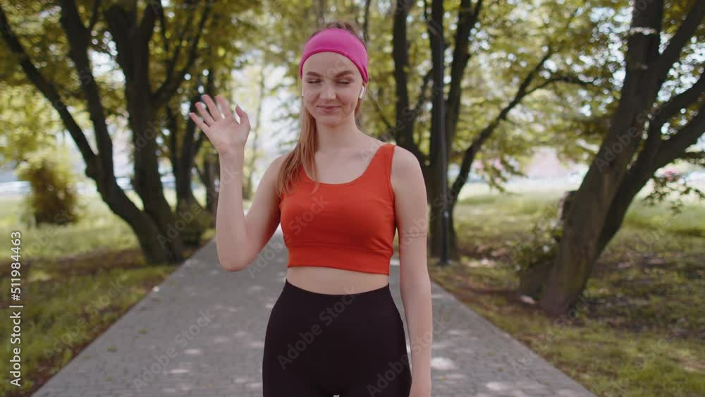Wow. Hello, welcome. Athletic fit slim runner girl waving hi with her ...