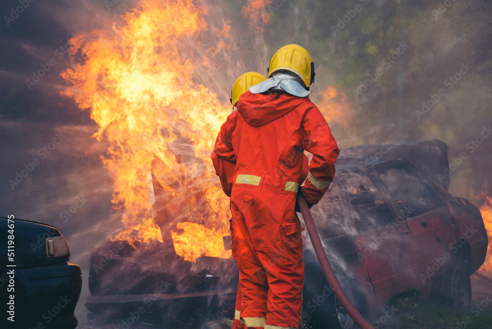 Firefighter fighting with flame using fire hose chemical water foam ...