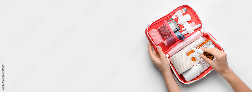 Female hands with first aid kit on light background with space for text ...