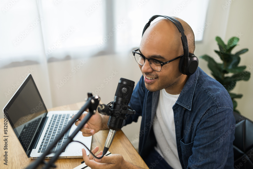 Content creator asia man host streaming his a podcast on laptop with ...