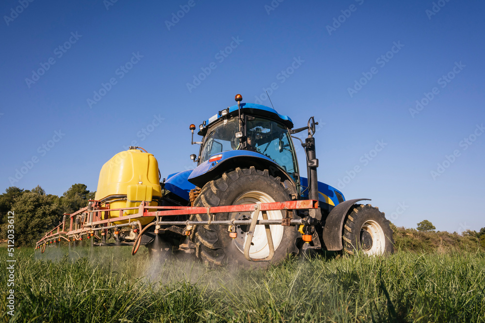 Crop sprayer spraying fertilizer on field Stock Photo | Adobe Stock