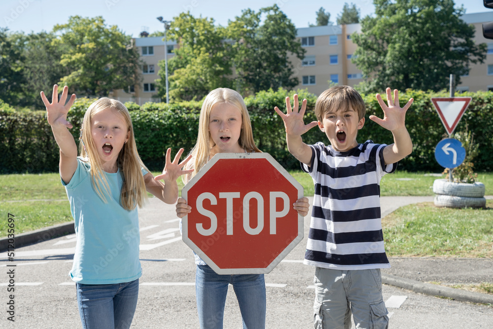Girl holding stop sign board standing by friends on sunny day Stock ...