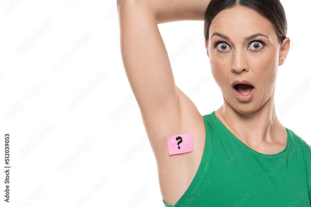 Woman shows her underarm with the question mark on her on white ...