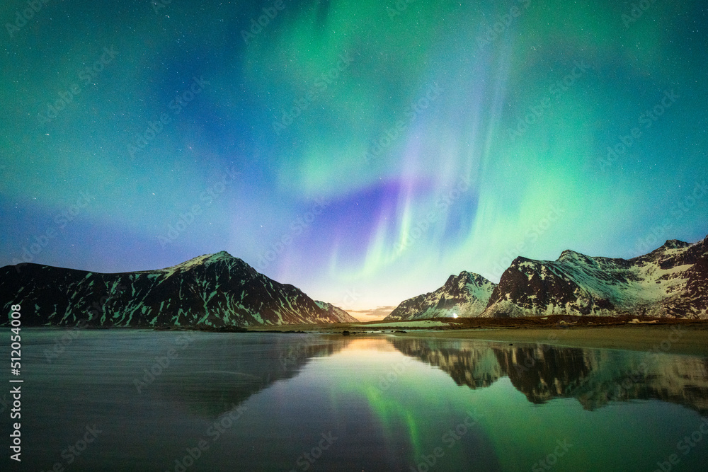 Bright night sky with Aurora Borealis (Northern Lights) over mountains ...