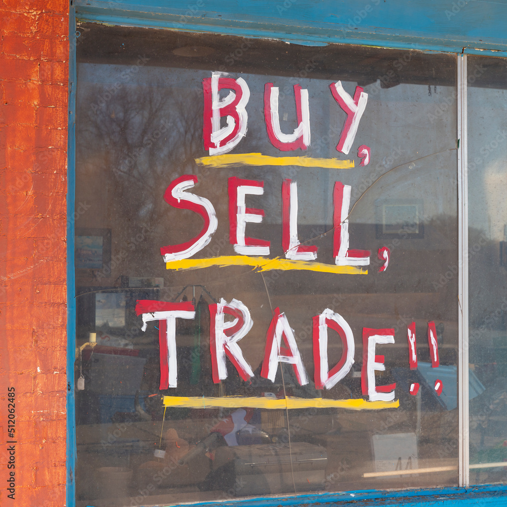 Buy Sell Trade sign in on old storefront window. Stock Photo | Adobe Stock