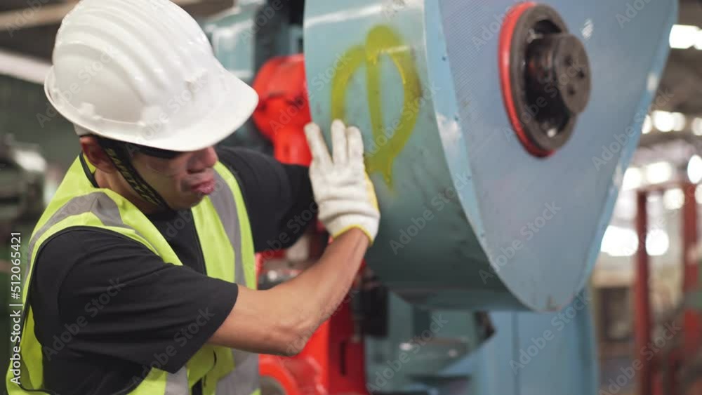 Asian male factory worker having accident arm stuck in the machine ...