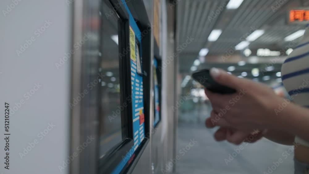 Cropped shot of young Asian woman scanning QR code, checking in at ...